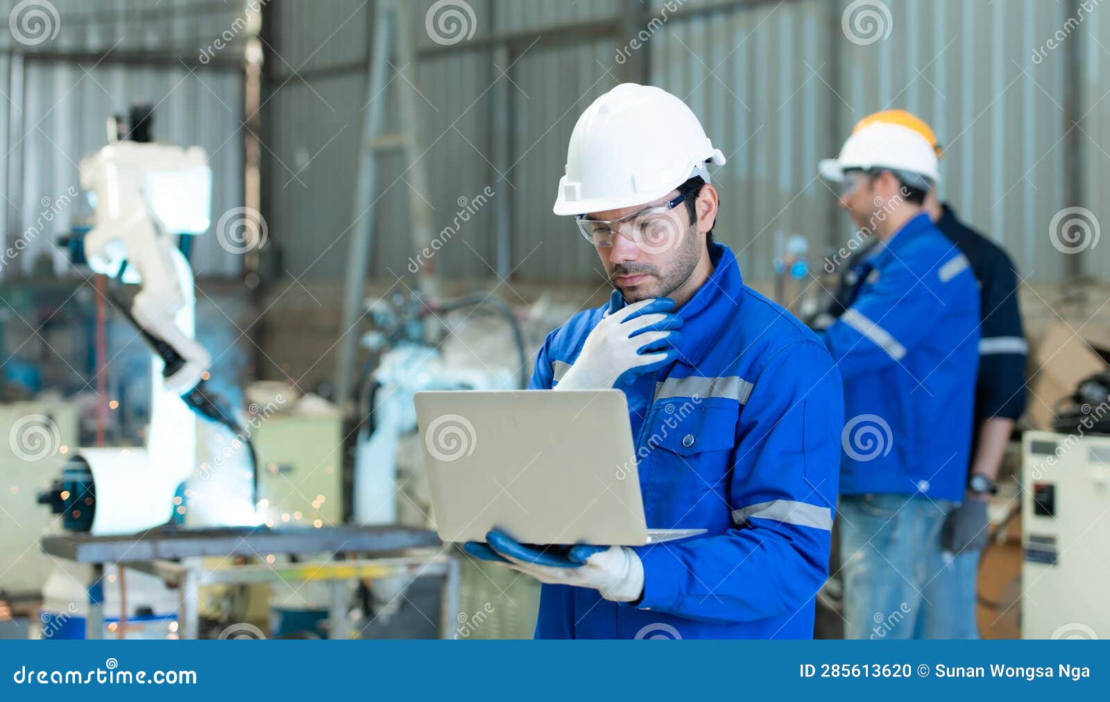 Group of Engineers are Manipulating a Welding Robot Hand. by Combining ...