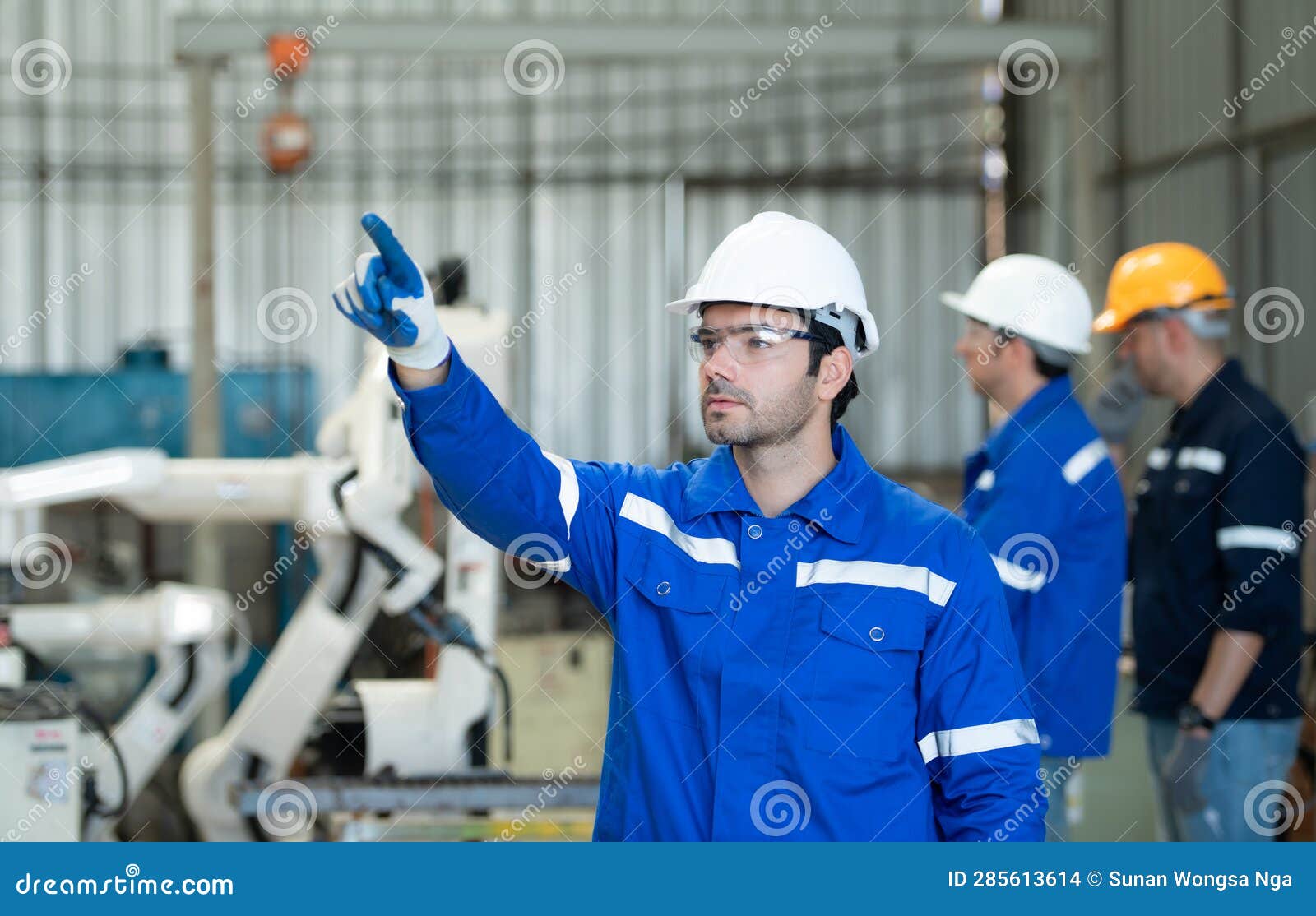 Group of Engineers are Manipulating a Welding Robot Hand. by Combining ...