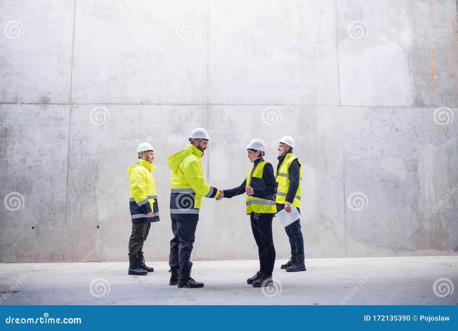 A Group of Engineers Standing on Construction Site, Shaking Hands ...