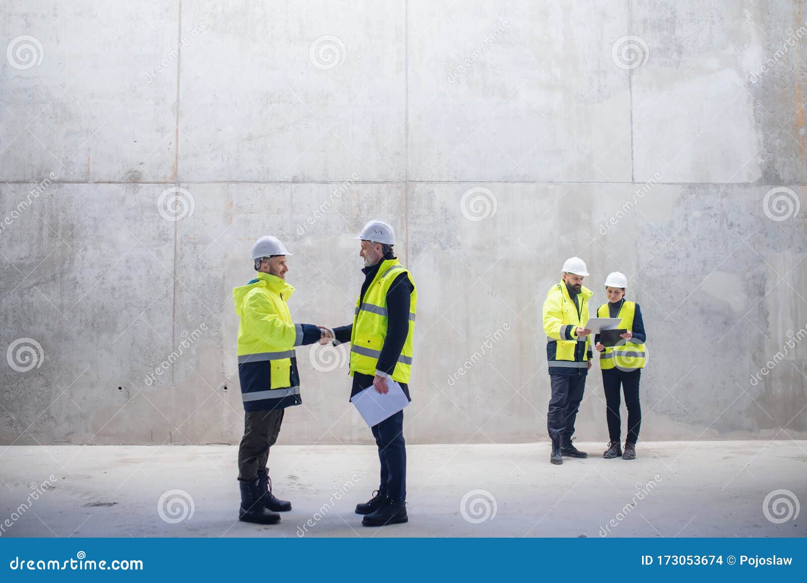 A Group of Engineers Standing on Construction Site, Shaking Hands ...