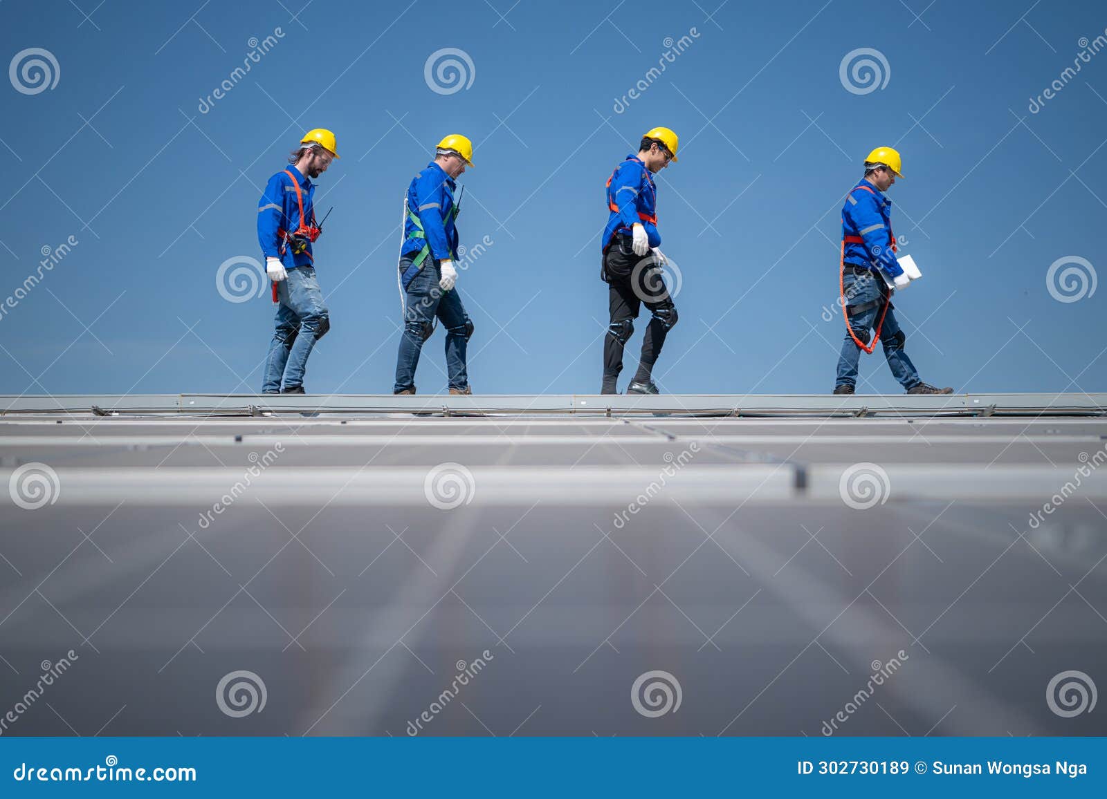 Group of Engineers Standing on Solar Panels with Blue Sky Stock Image ...