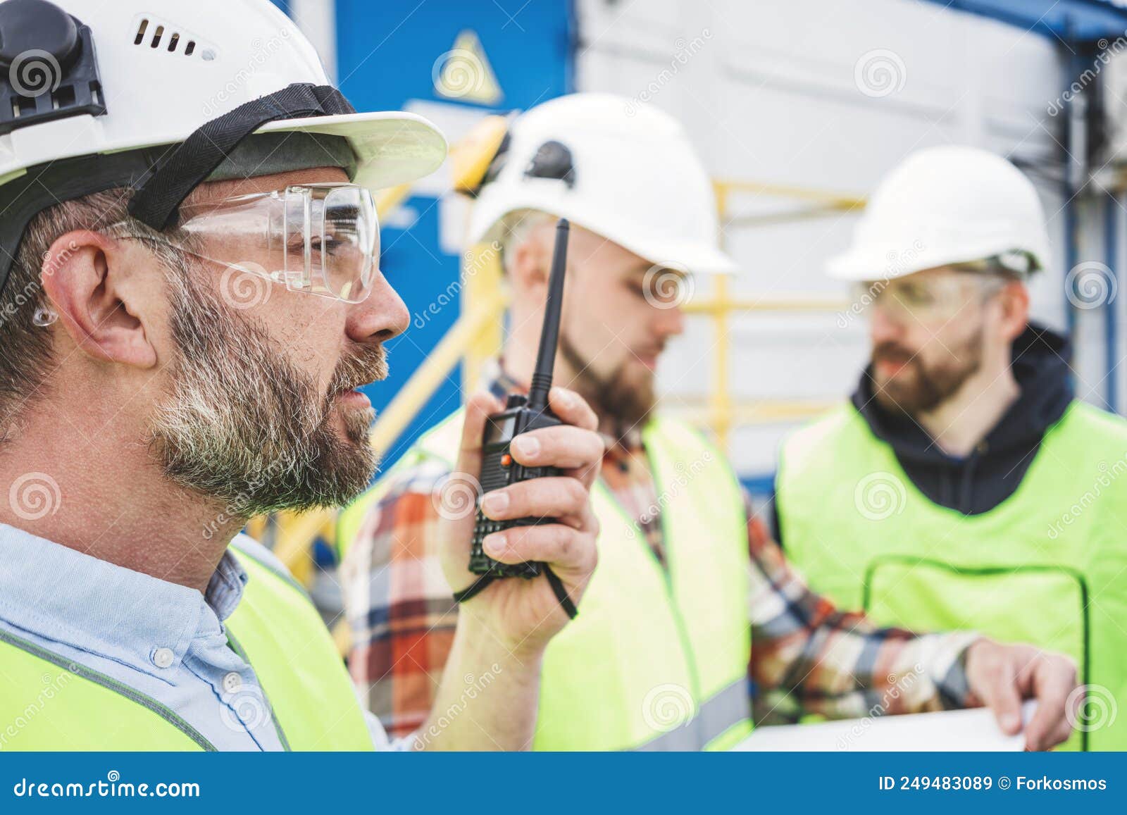 Group of Engineers Using Walkie-talkie Talking on Produce Site Stock ...