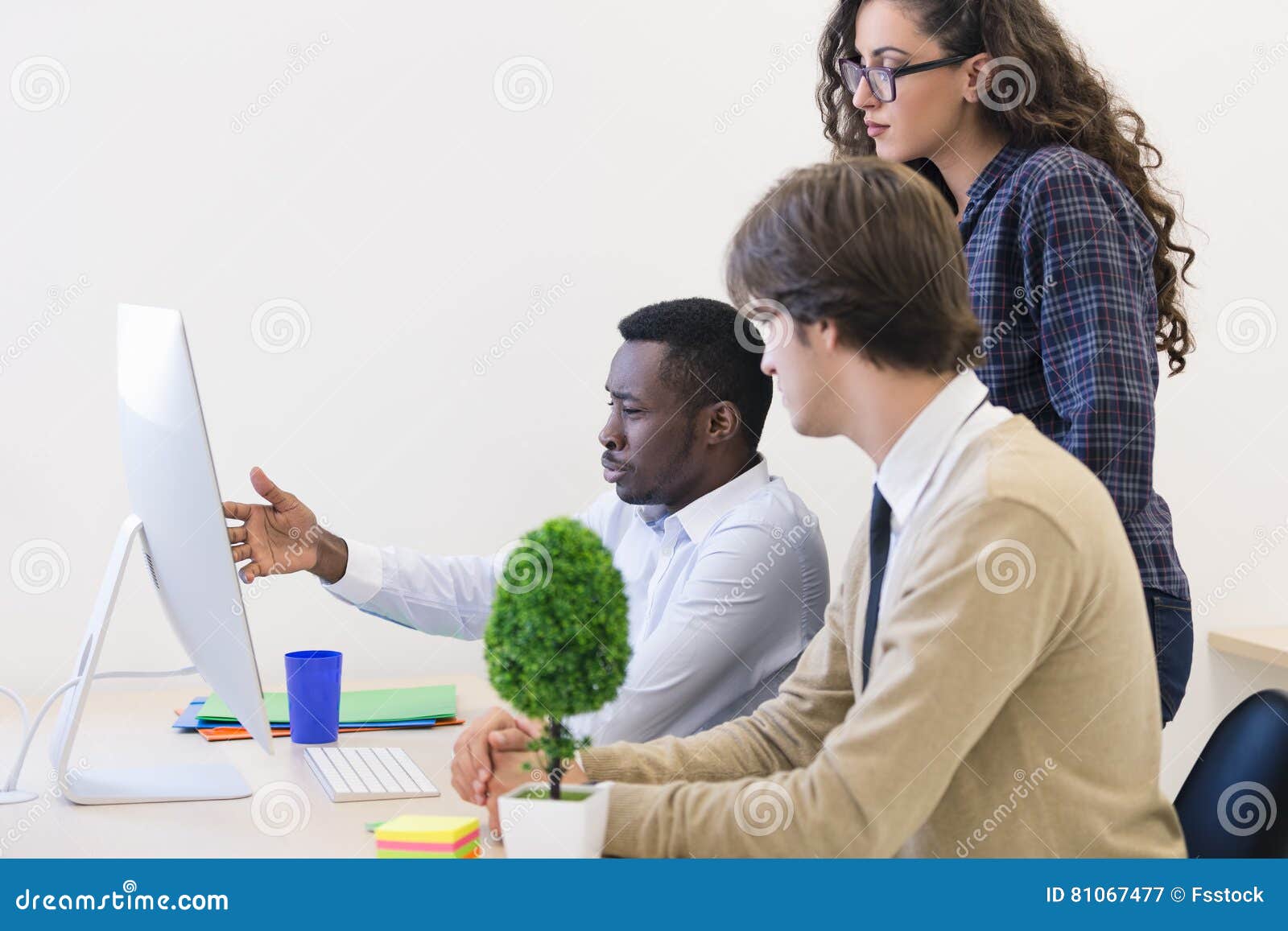 Group of Entrepreneurs Working Using a Laptop and Holding a Docu Stock ...