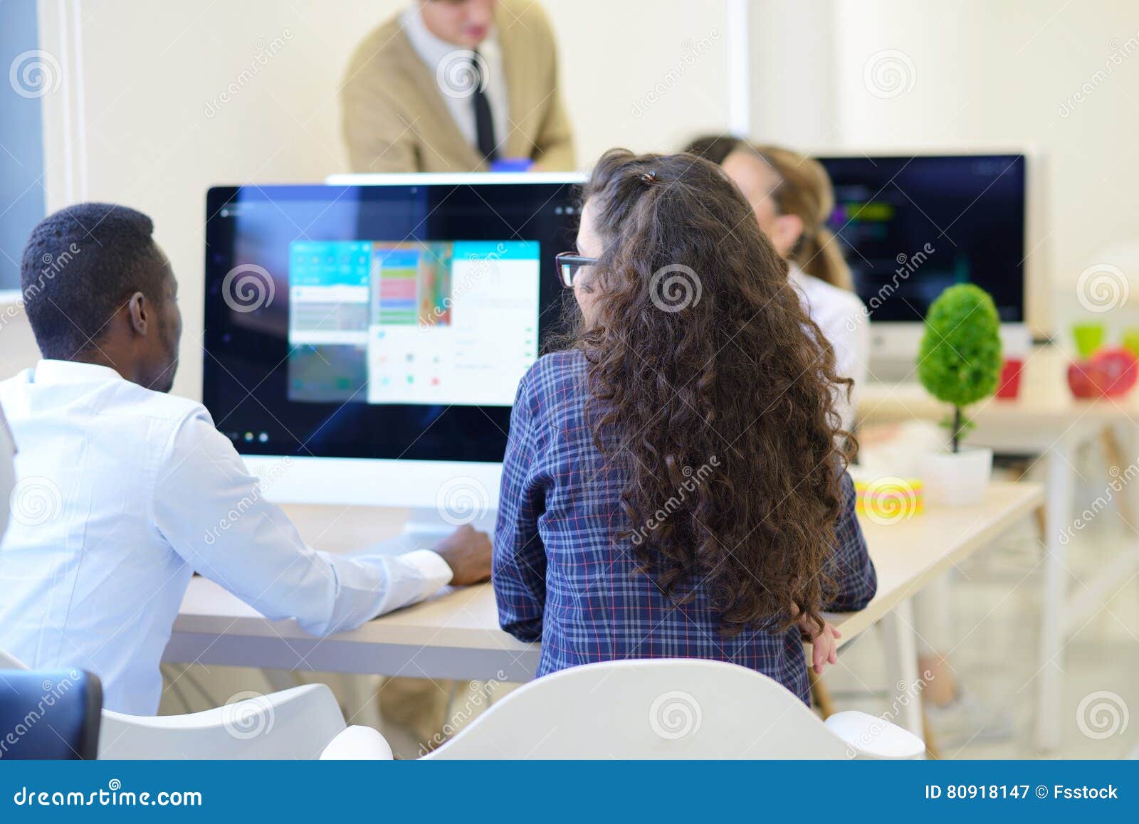 Group of Entrepreneurs Working Using a Laptop and Holding a Document ...