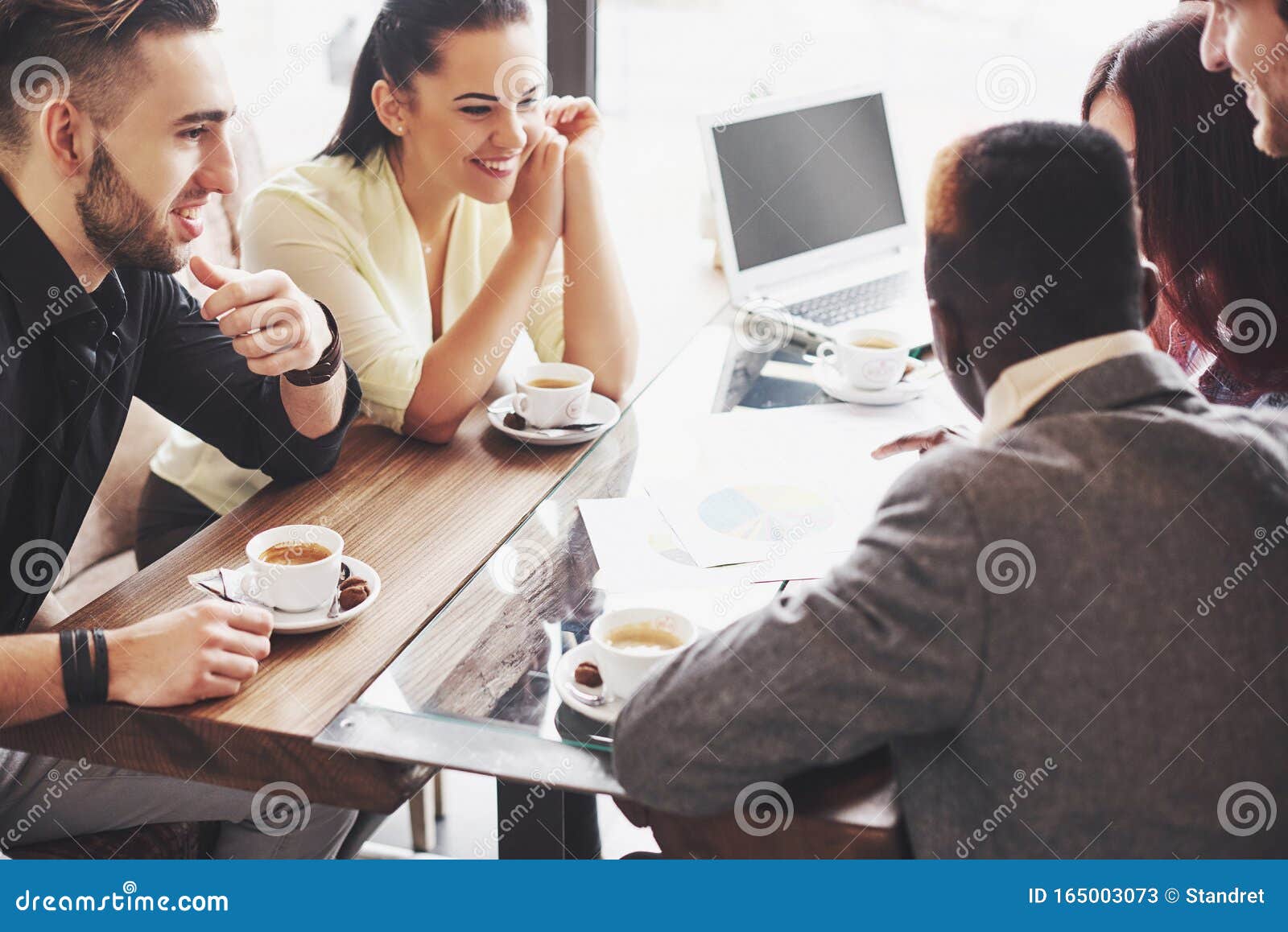Group of Entrepreneurs Working Using a Laptop and Holding a Document ...