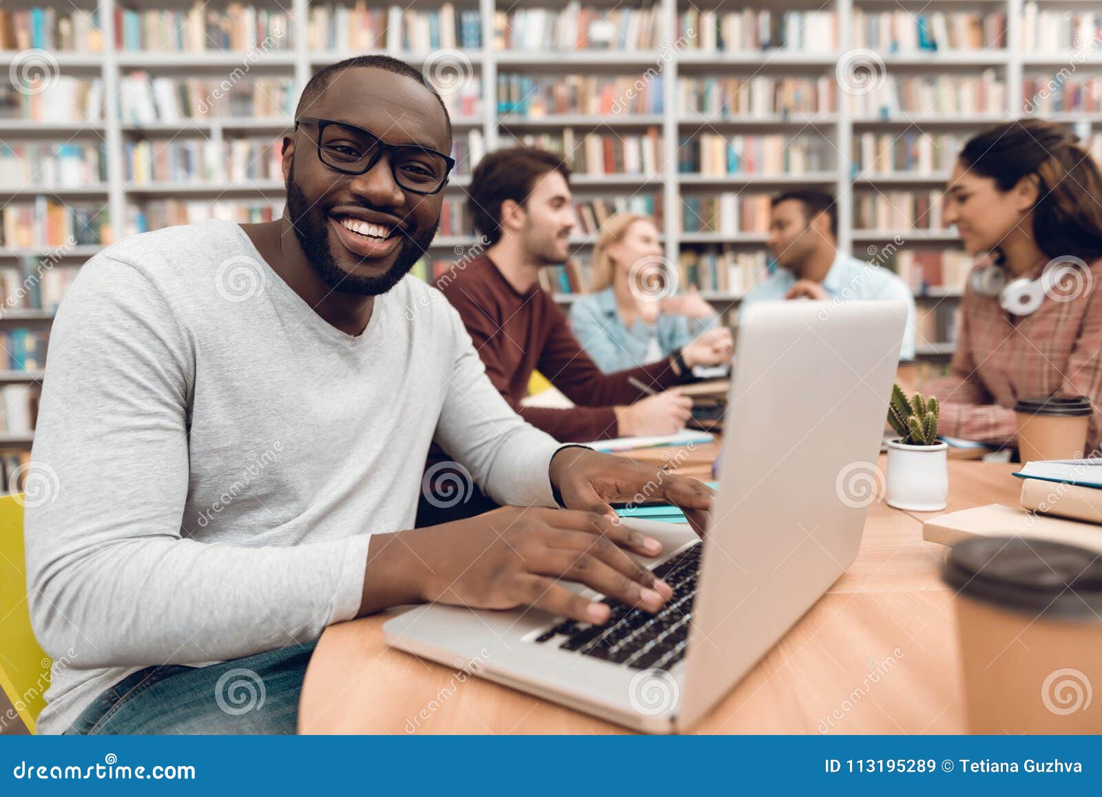Group of Ethnic Multicultural Students in Library. Black Guy on Laptop ...