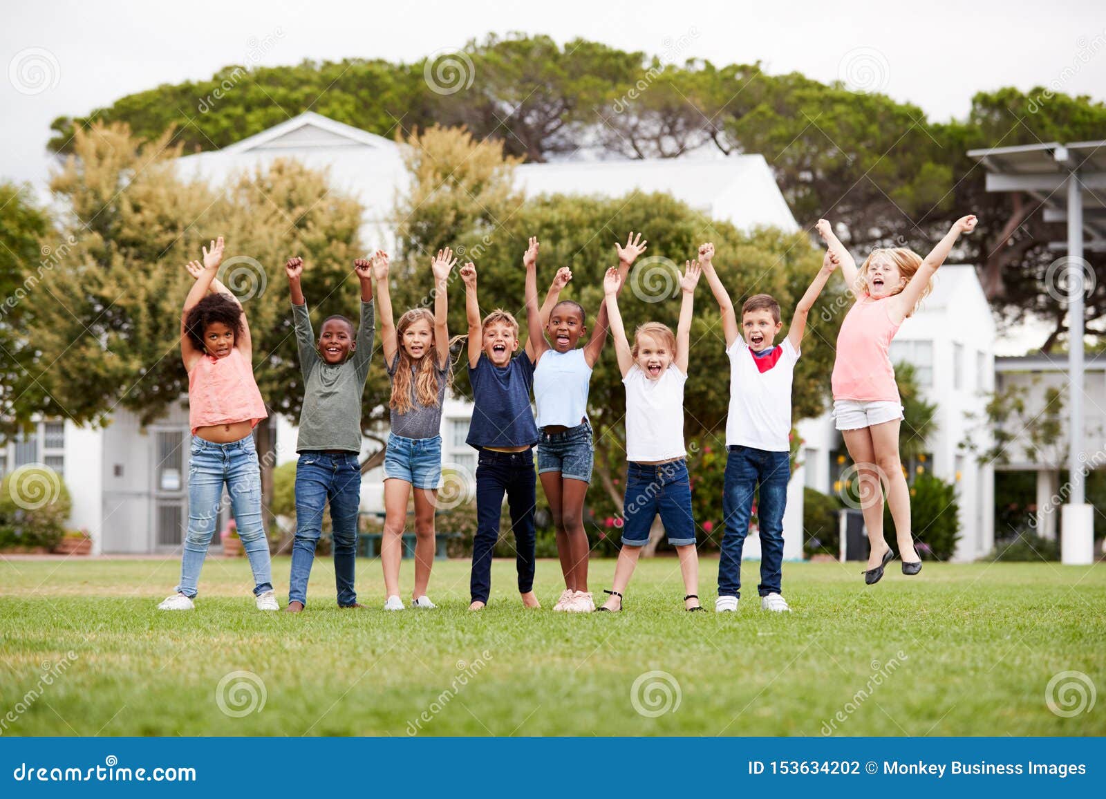Group of Excited Elementary School Pupils Standing on Playing Field at ...