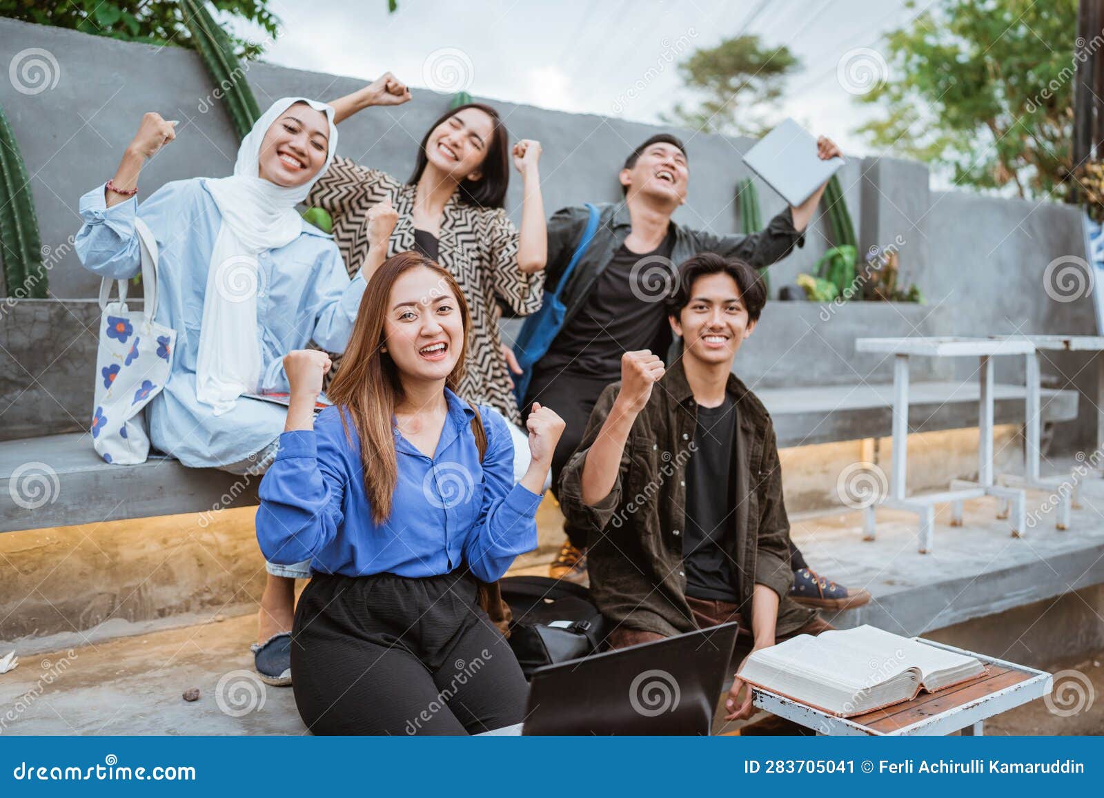 Group of Excited Students Studying with a Laptop Outside the Campus ...