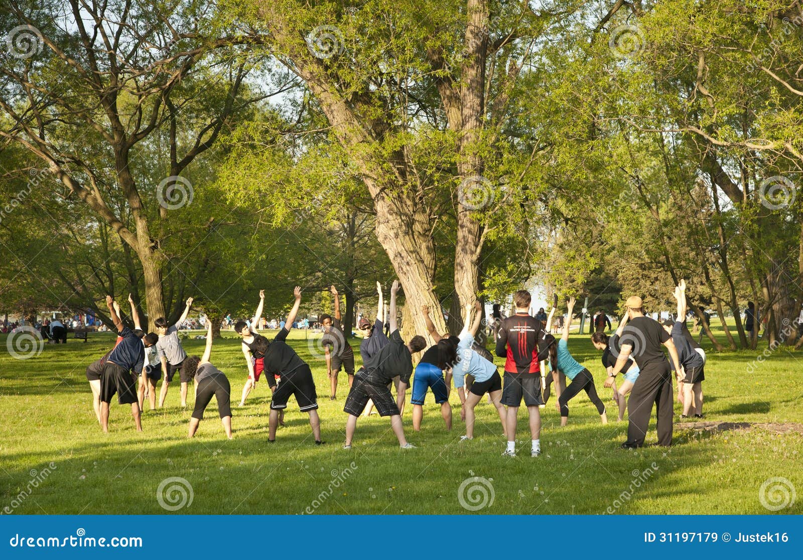Group exercises in a park editorial stock image. Image of african ...