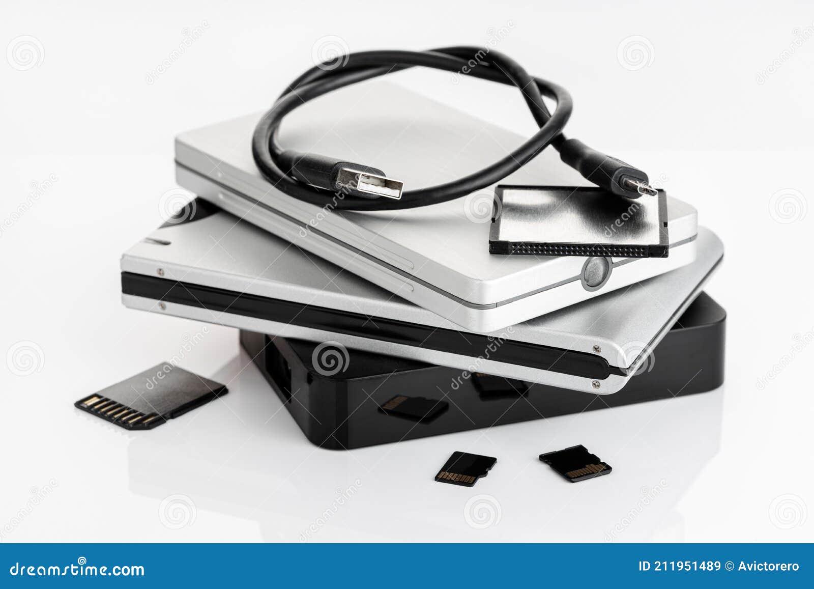 Group of External Hard Disks and Memory Cards on White Table Stock ...
