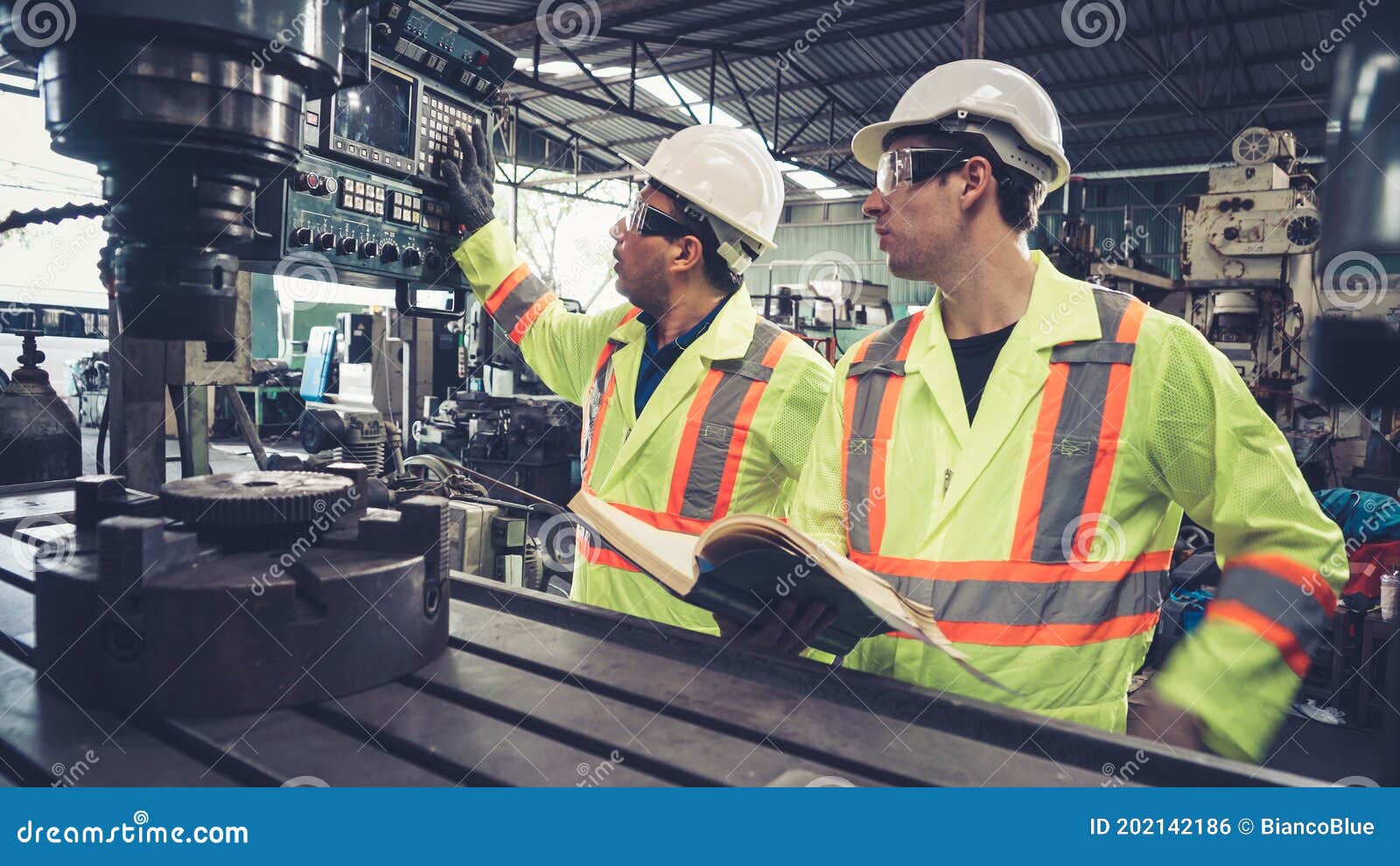 Group of Factory Workers Using Machine Equipment in Factory Workshop ...