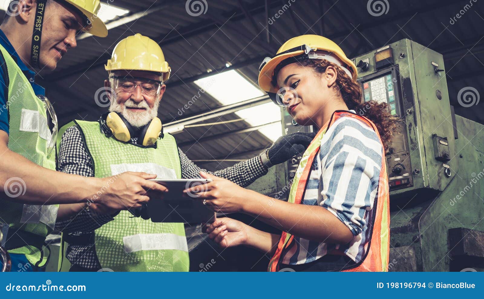 Group of Factory Workers Using Machine Equipment in Factory Workshop ...