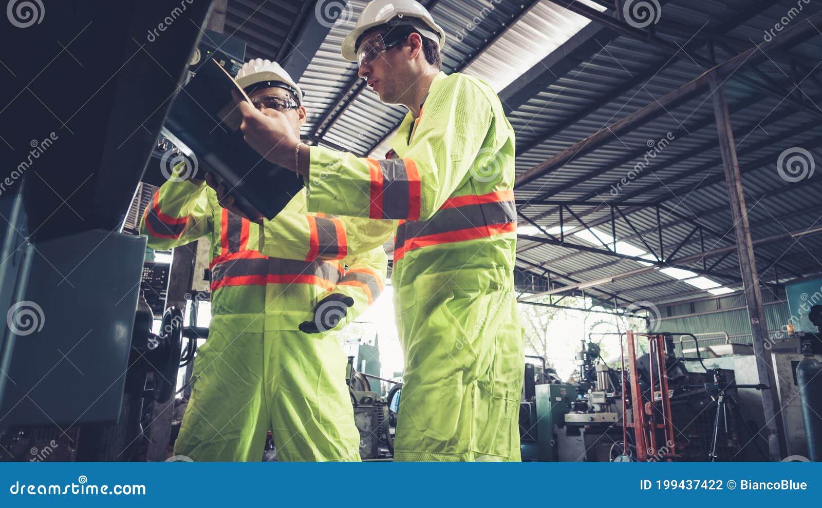 Group of Factory Workers Using Machine Equipment in Factory Workshop ...