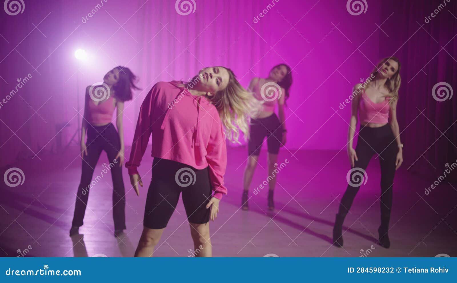A Group of Female Dancers, Led by Trainer, Begin a Class in High Heels ...