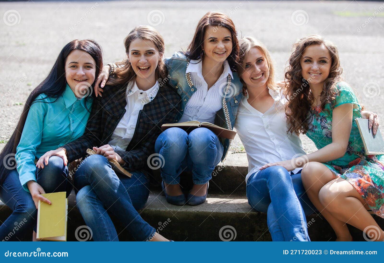 A Group of Female Students Sitting with Books in the Courtyard of the ...