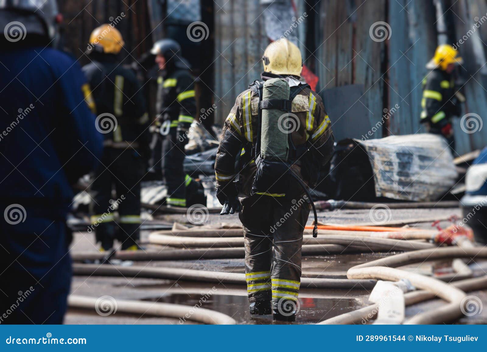 Group of Fire Men in Protective Uniform during Fire Fighting Operation ...