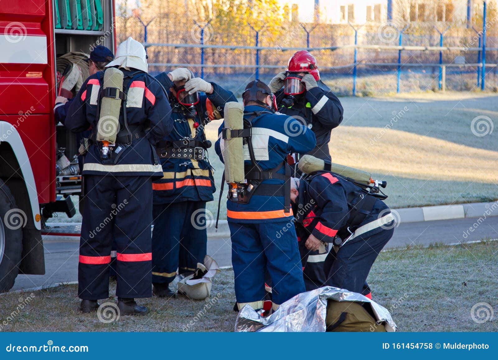 Group of Firemen Putting on Gas Masks and Preparing for Extinguish Fire ...