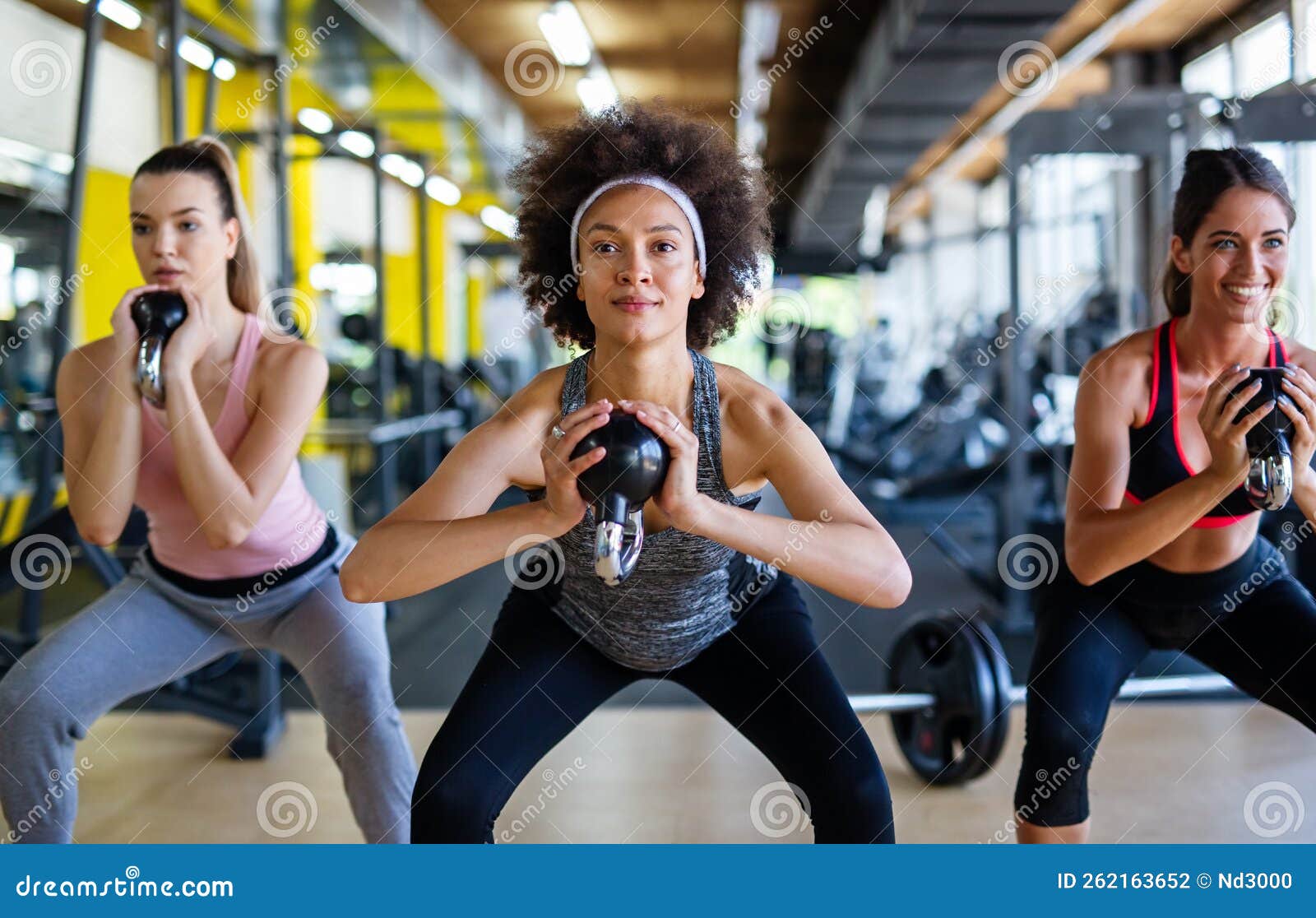 Group of Fit People Lifting Dumbbells during an Exercise Class at the ...
