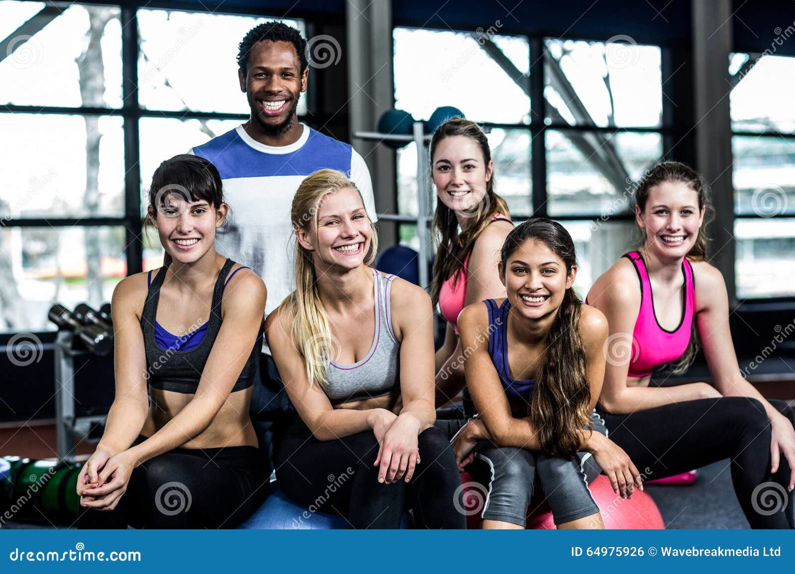Group of Fit People Smiling while Sitting on Exercise Balls Stock Photo ...