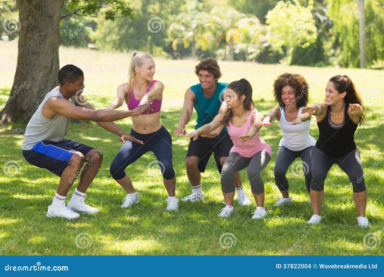Group of Fitness Class Exercising in Park Stock Photo - Image of ...