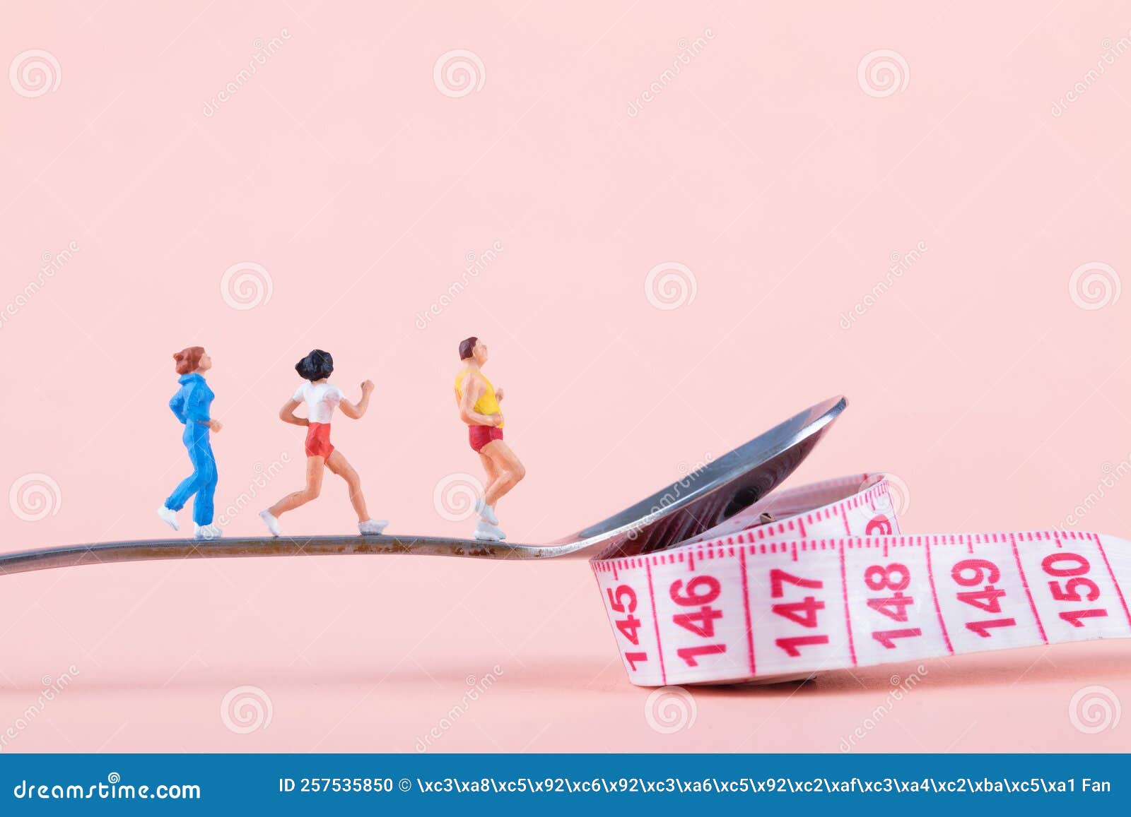 A Group of Fitness Miniature Figures Running on a Spoon Stock Photo ...