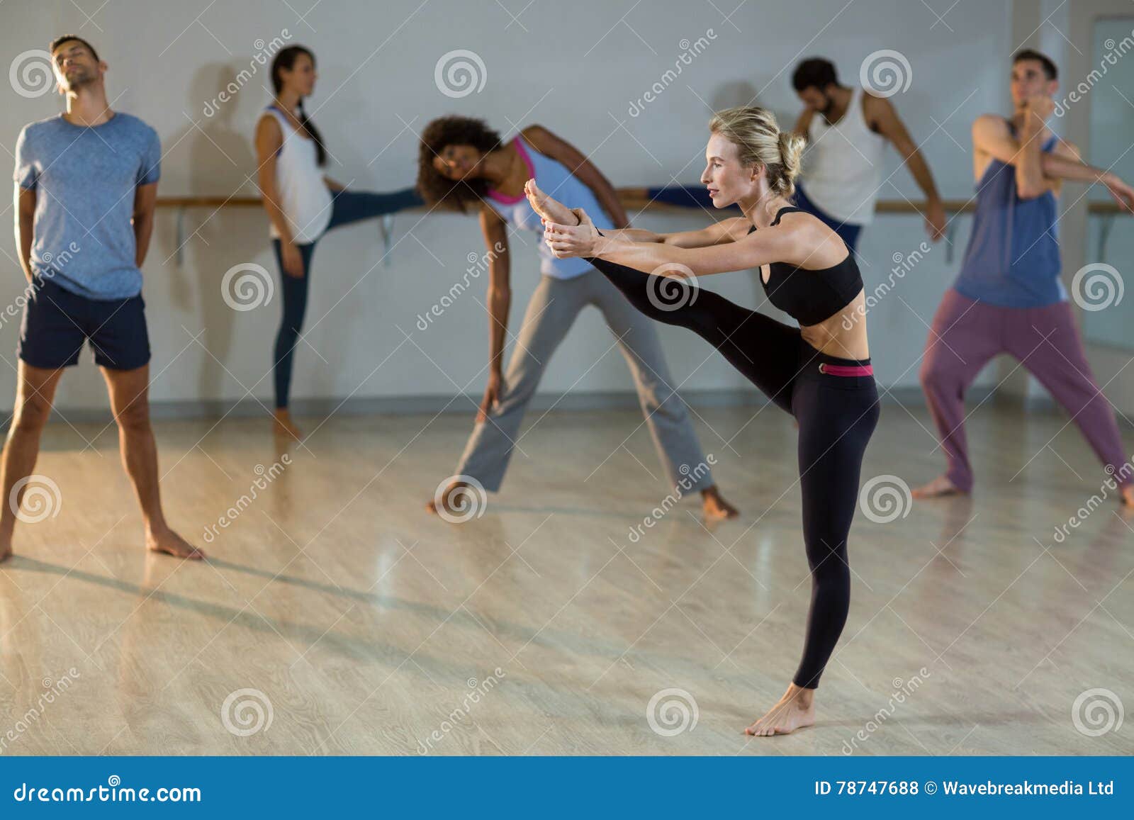 Group of Fitness Team Performing Stretching Exercise Stock Photo ...