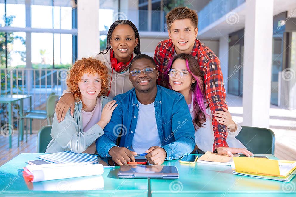 Happy Diverse Group of Students Studying in the Library Looking at ...