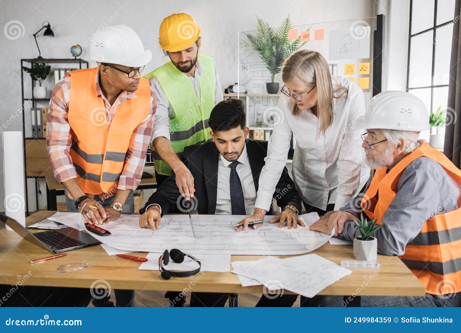 Group of Five Multiracial People in Suits and Helmets Brainstorming for ...