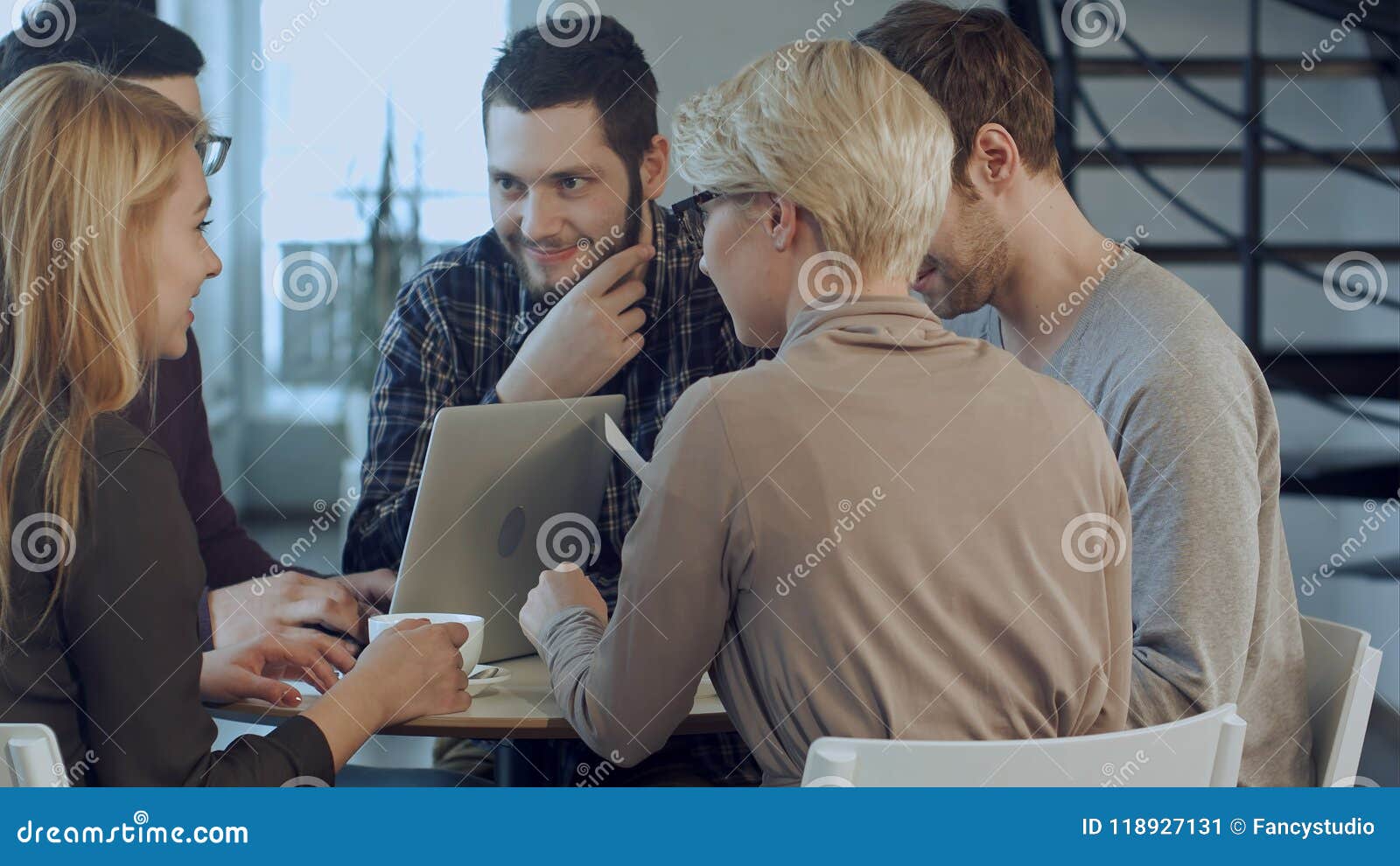 Group of Five People Discussing Something with Smile while Sitting at ...