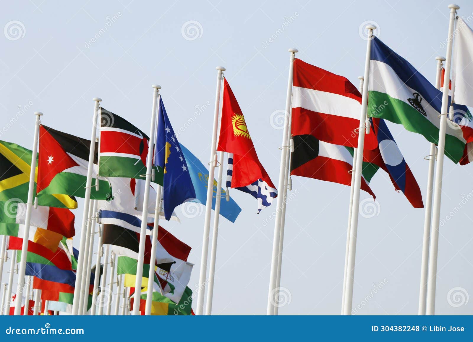 Group of Flags of Many Different Nations Against Blue Sky Stock Photo ...