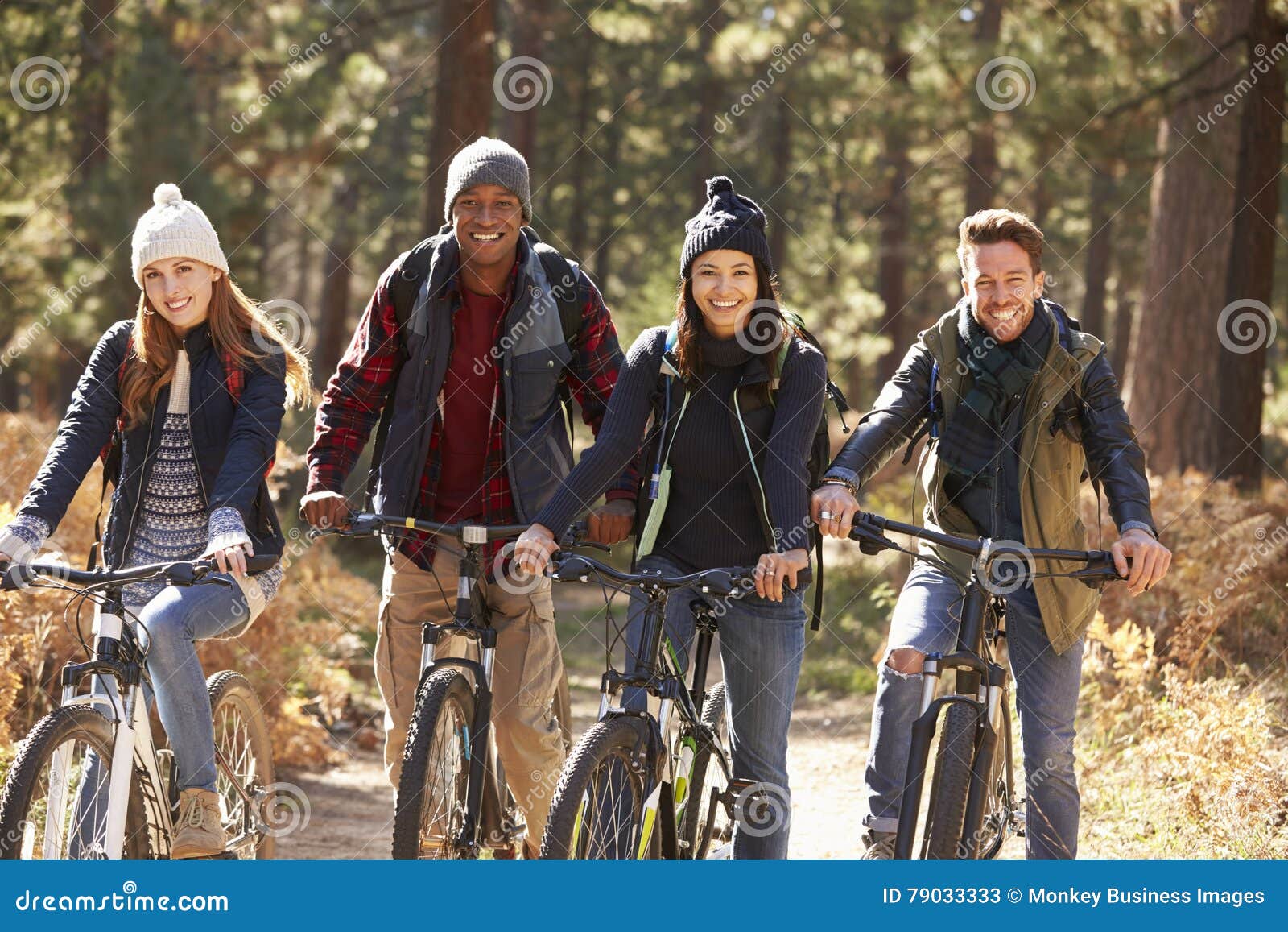 Group of Four Friends on Bikes in a Forest Looking To Camera Stock ...