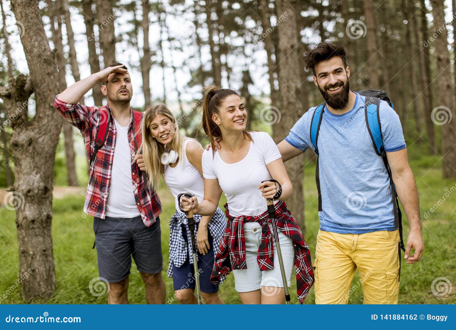 Group of Four Friends Hiking Together through a Forest Stock Photo ...