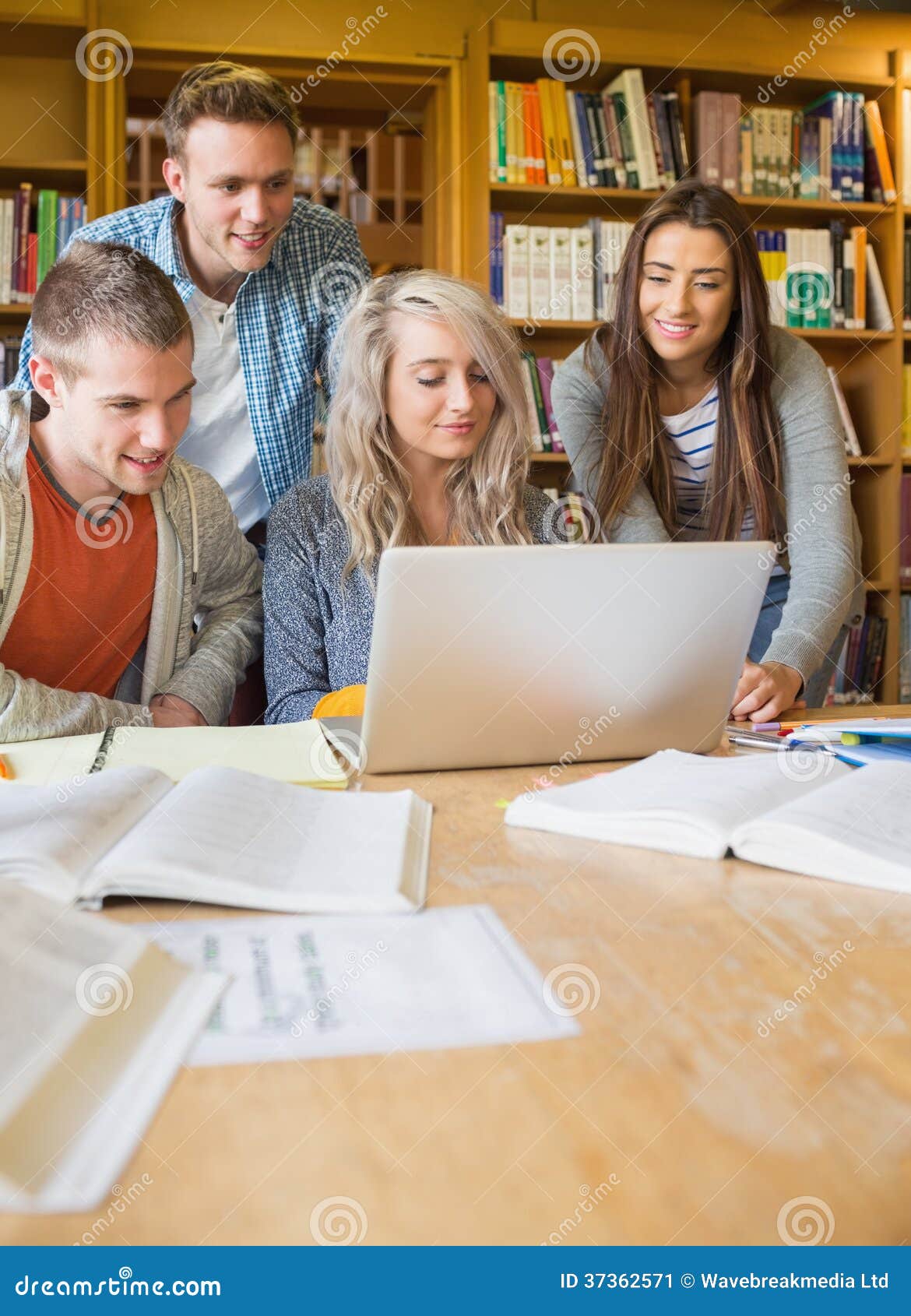 Happy Students Using Laptop at Desk in Library Stock Image - Image of ...