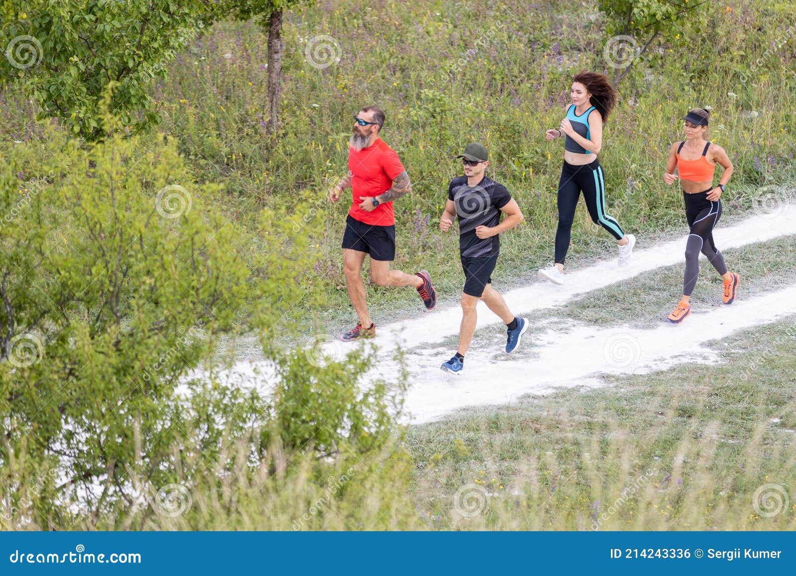 Group of Four Young People Run on the Country Road Stock Photo - Image ...