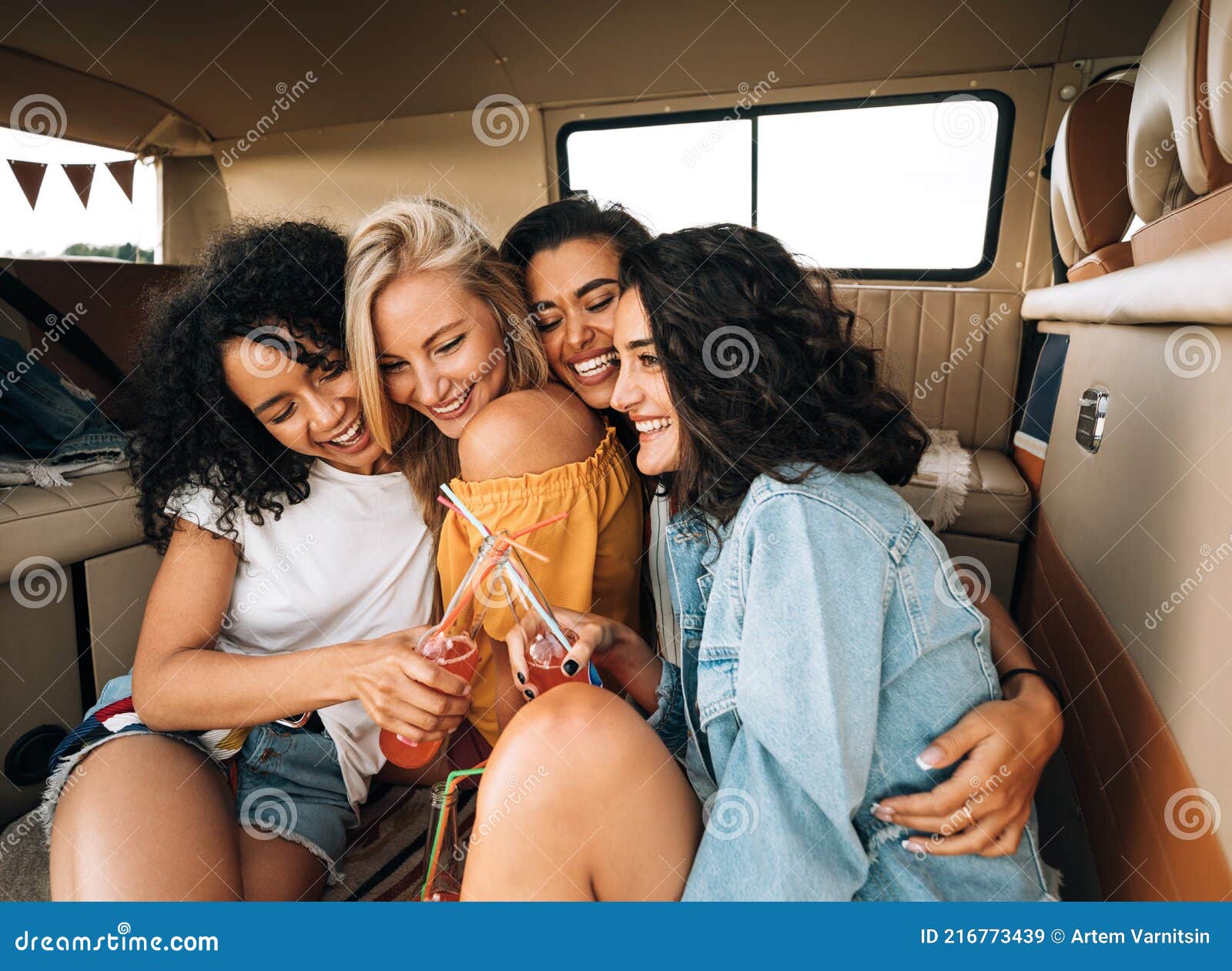 Group of Four Young Women Cuddling Each Other while Sitting in Van ... Group of Four Young Women Cuddling Each Other while Sitting in Van ...