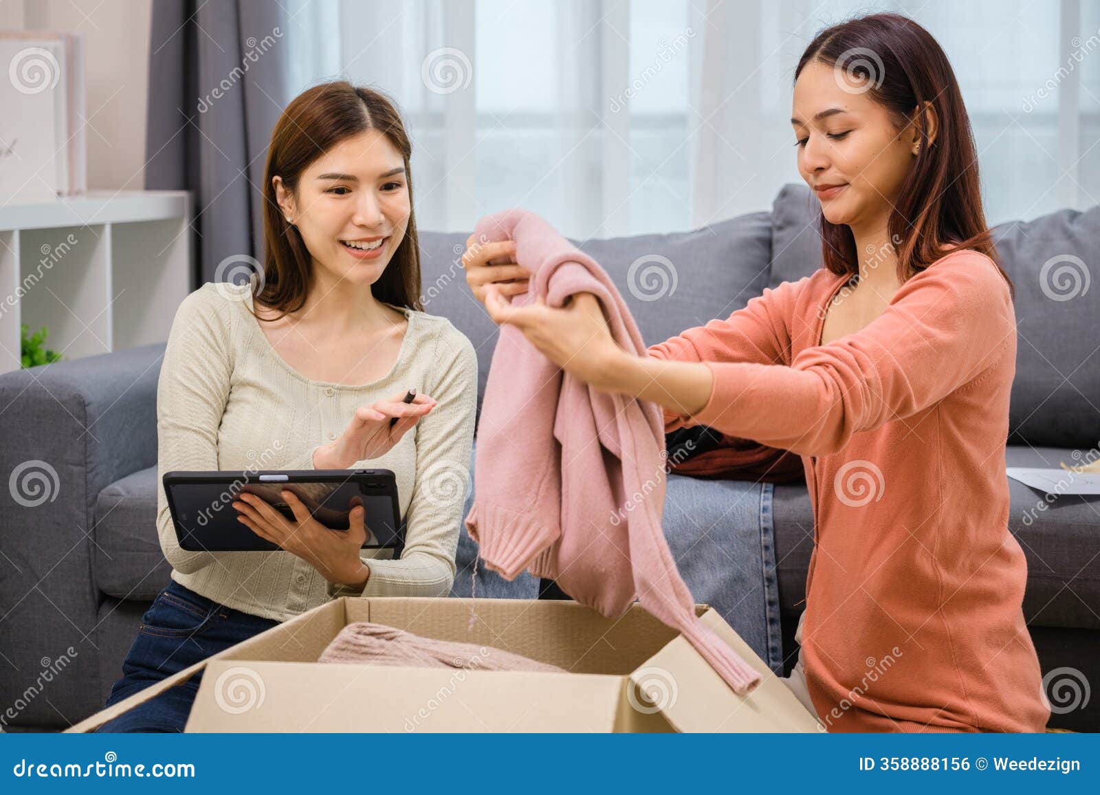 Group of Friend Sorting and Packing Clothes into a Donation Box ...