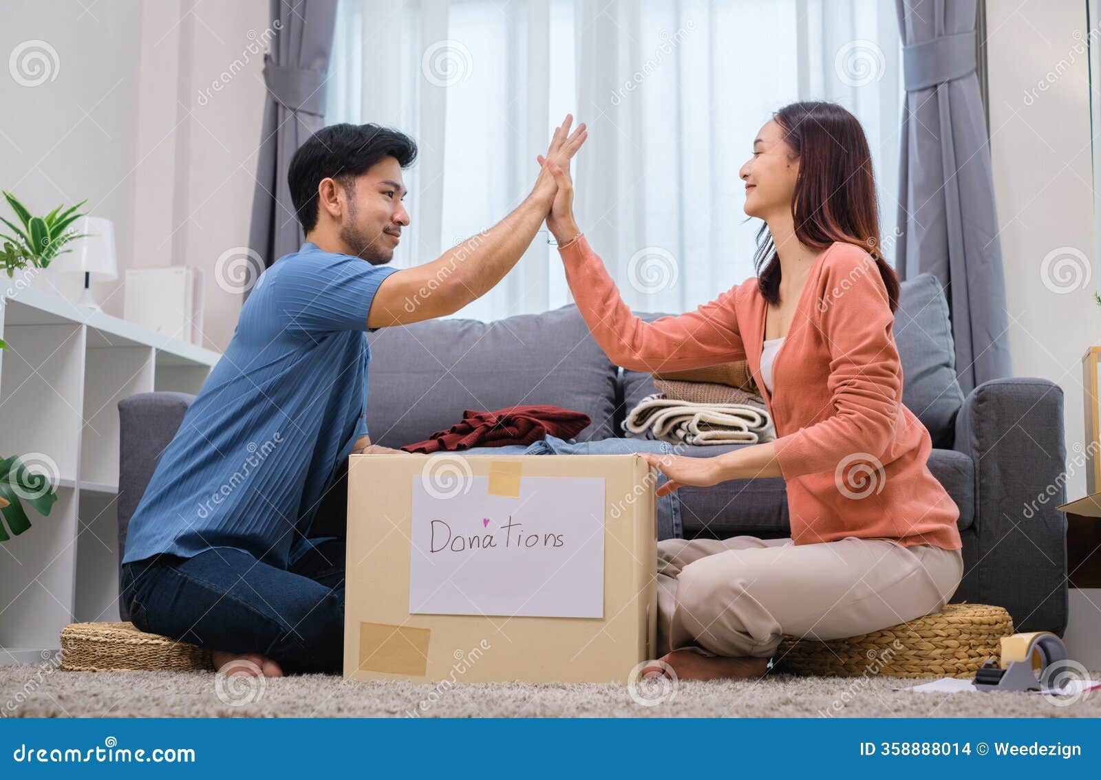 Group of Friend Sorting and Packing Clothes into a Donation Box ...