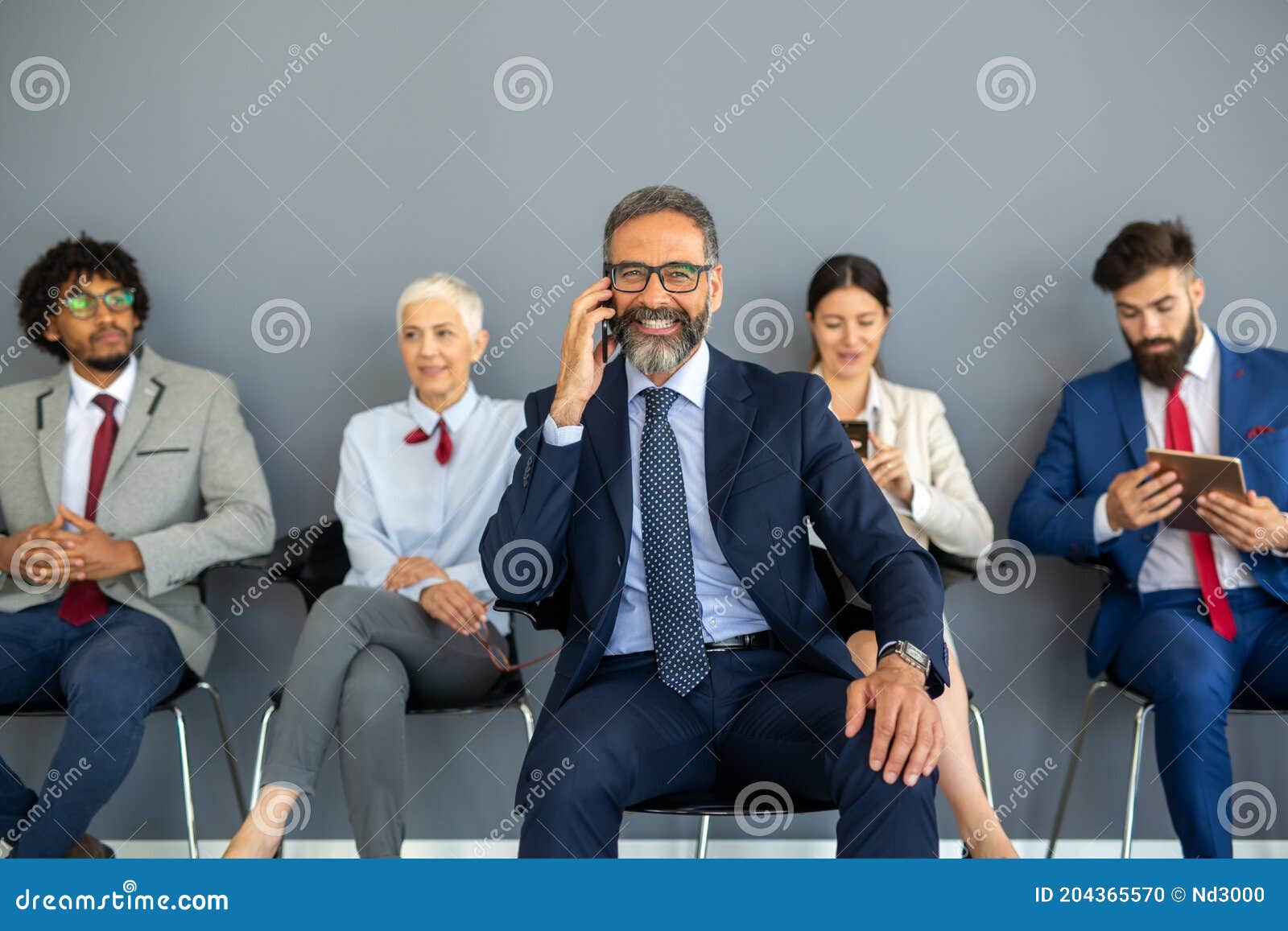 Group of Friendly Businesspeople with Male Leader in Front Stock Photo ...
