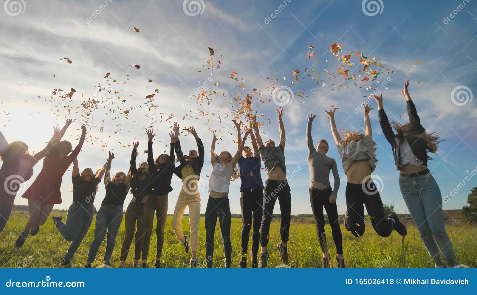 A Group of Friendly Friends Toss Up Candy at Sunset in a Field. Stock ...