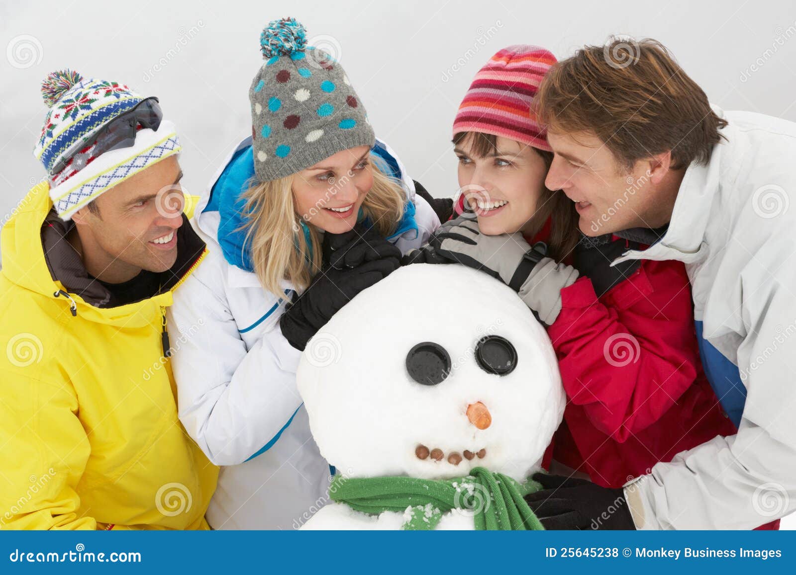 Group of Friends Building Snowman on Ski Holiday Stock Photo - Image of ...