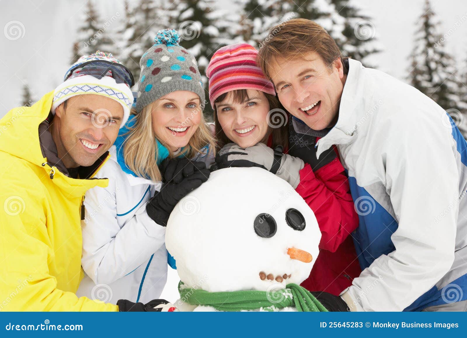 Group of Friends Building Snowman on Ski Holiday Stock Image - Image of ...