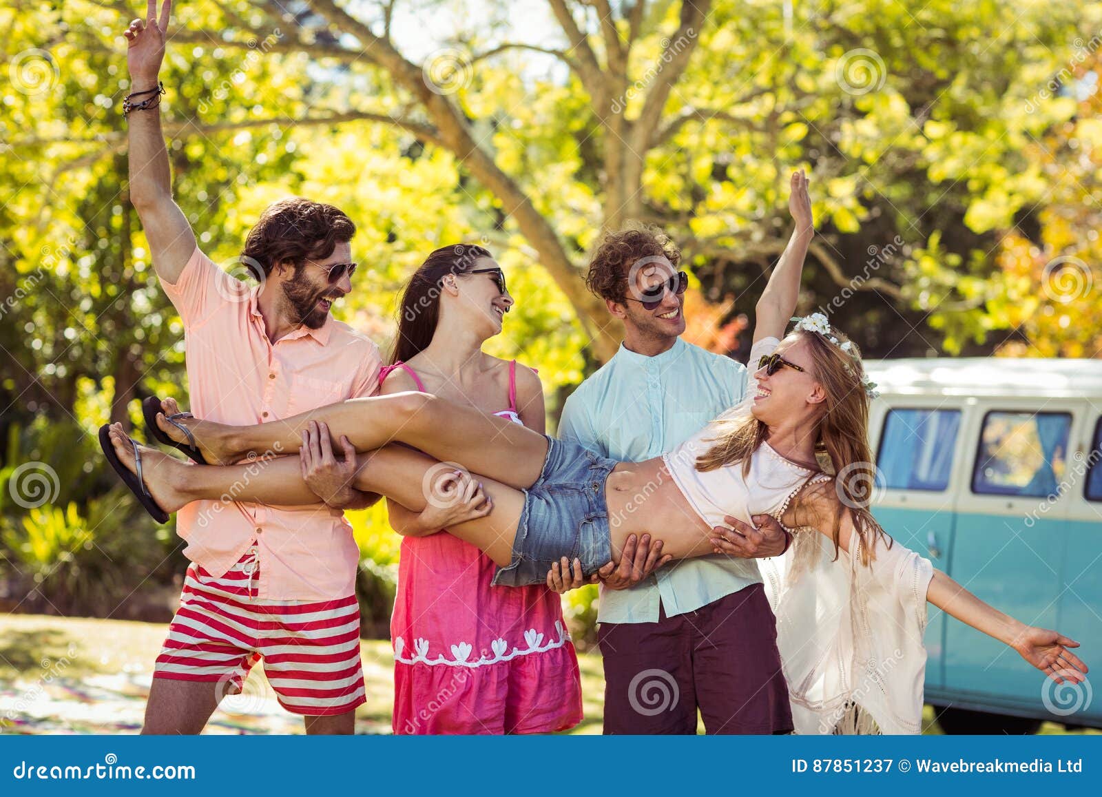 Group of Friends Carrying a Women in Park Stock Image - Image of ...