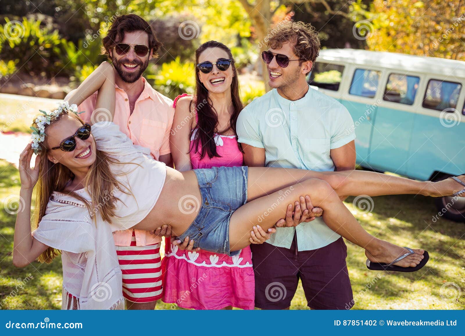 Group of Friends Carrying a Women in Park Stock Photo - Image of ...