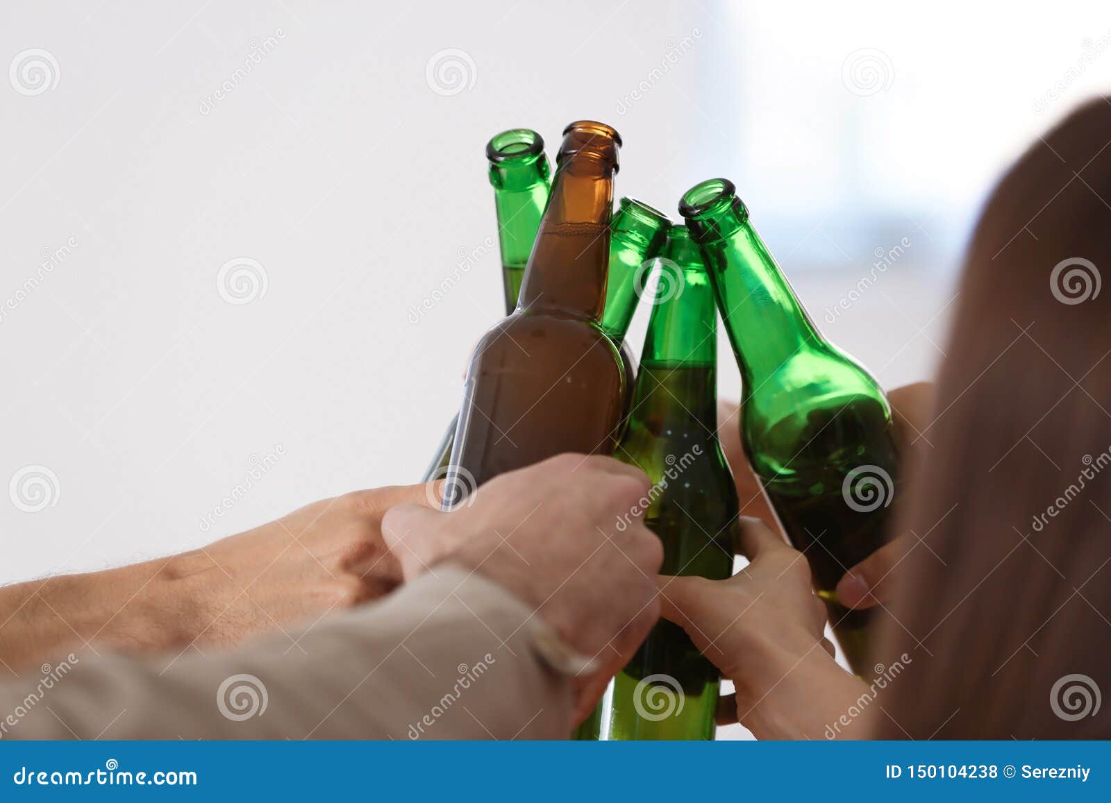 Group of Friends Clinking Bottles with Beer in Bar Stock Photo - Image ...