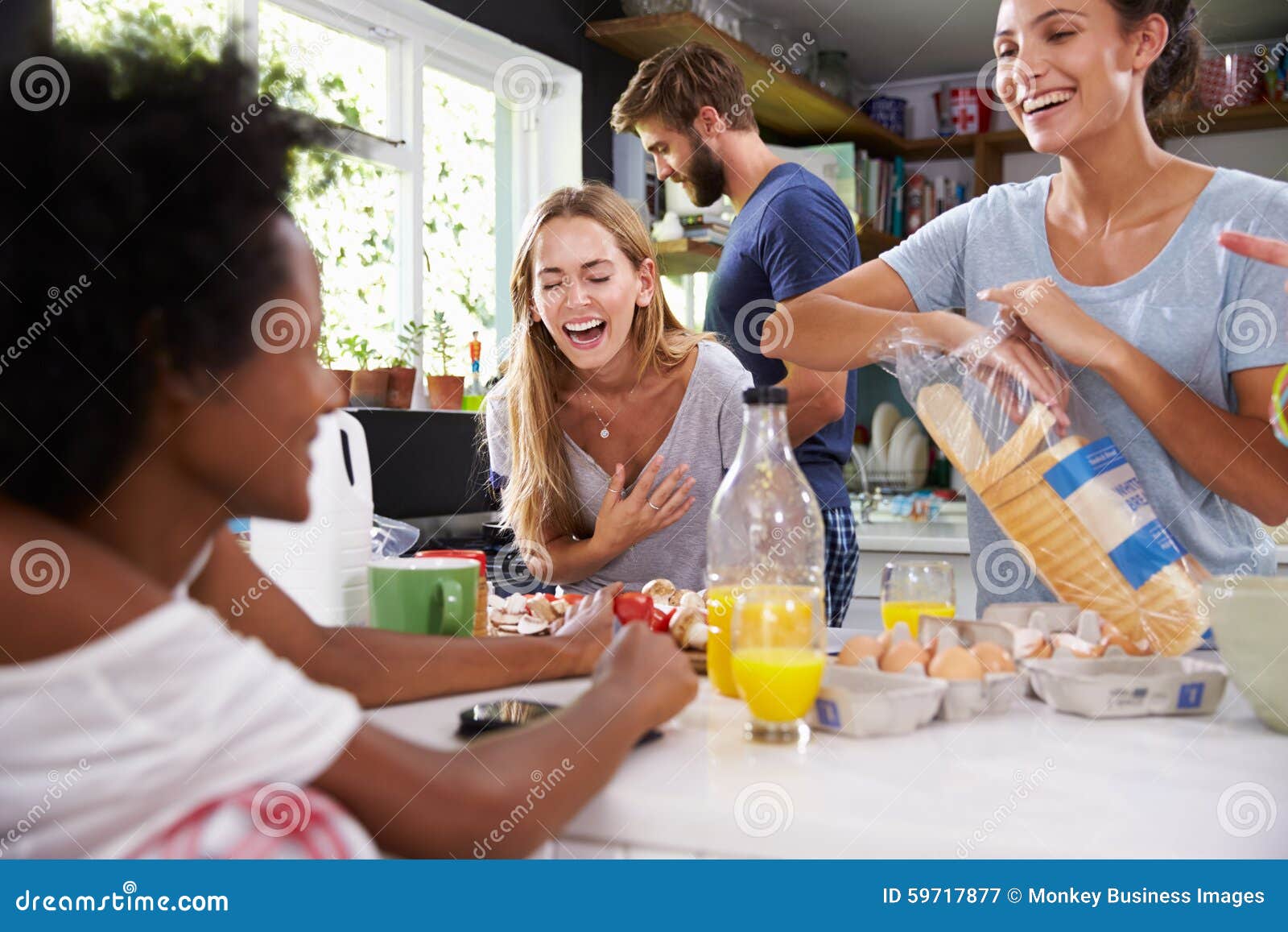 Group of Friends Cooking Breakfast in Kitchen Together Stock Image ...