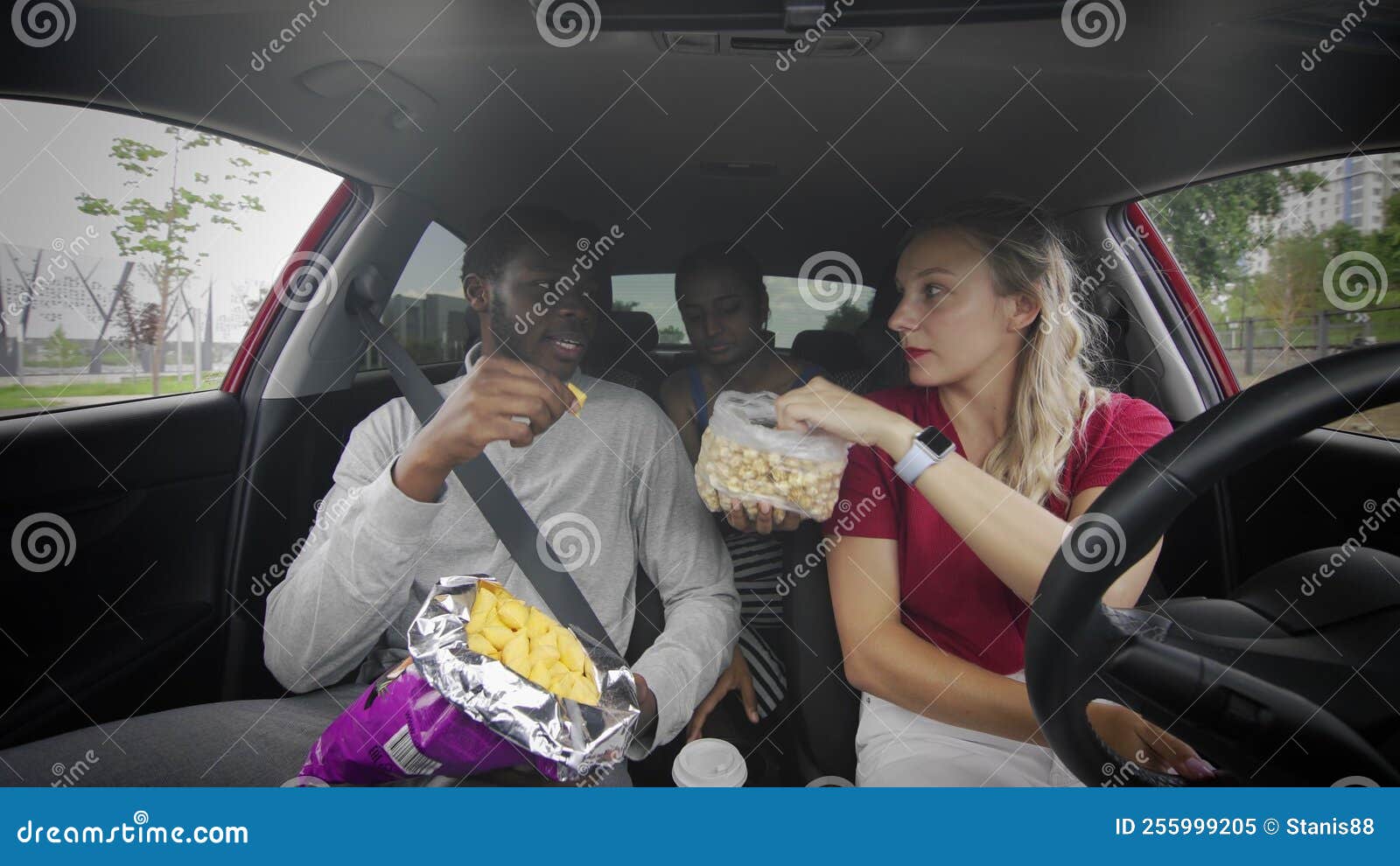 A Group of Friends of Different Nationalities are Eating in the Car ...