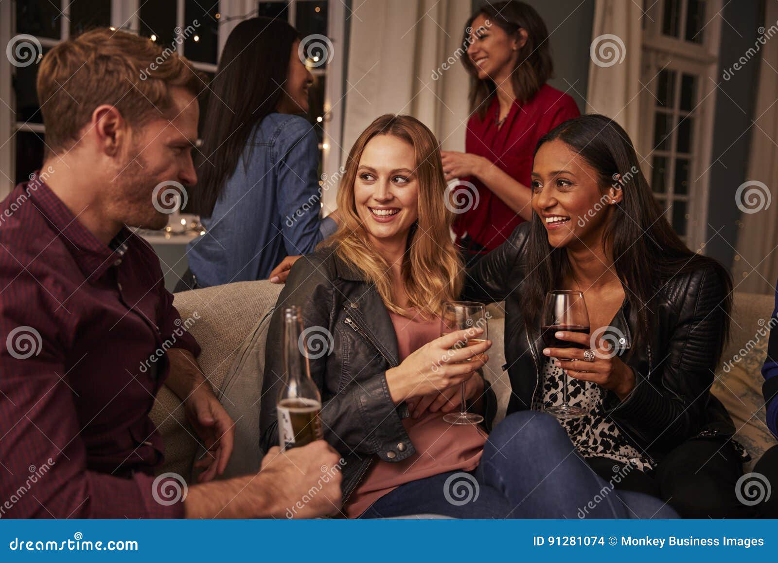 Group of Friends with Drinks Enjoying House Party Together Stock Photo ...