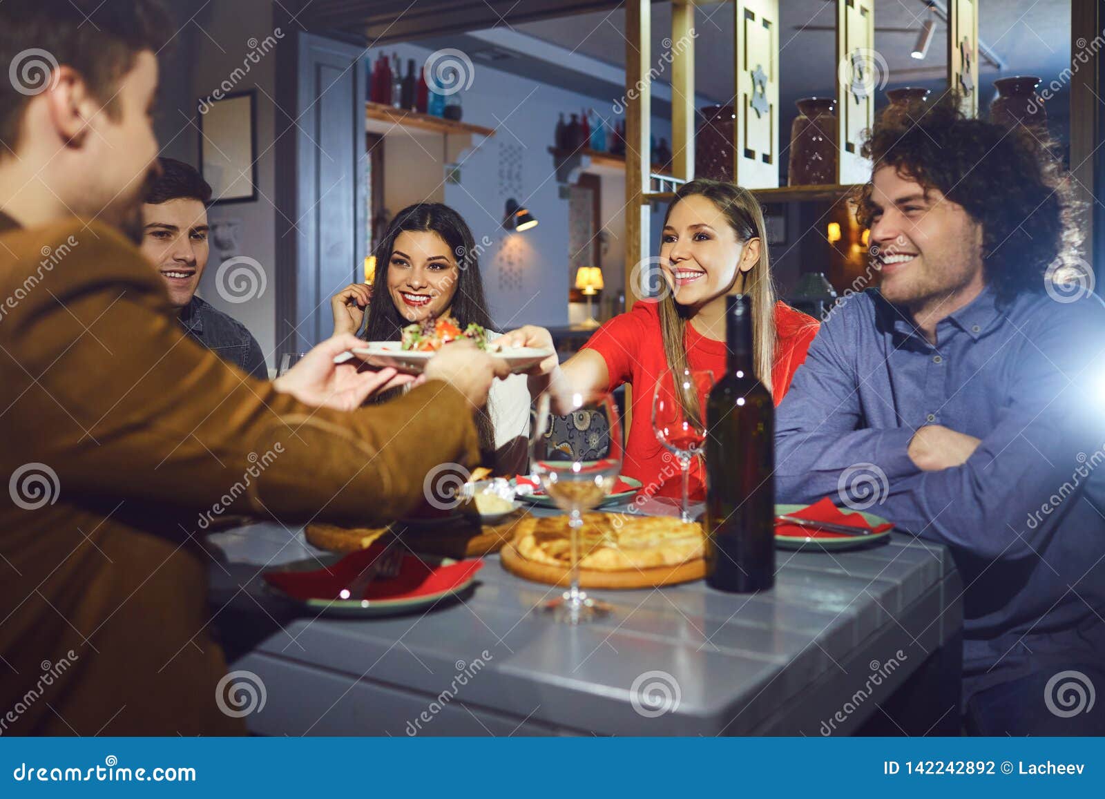 A Group of Friends Eating at a Dinner in a Restaurant. Stock Photo ...