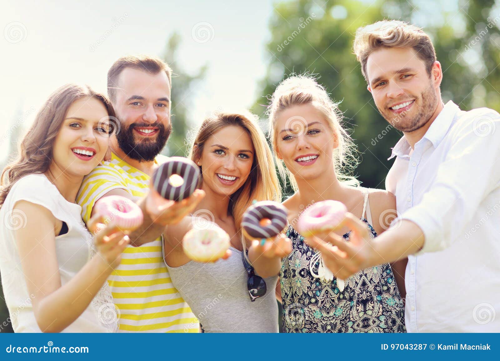 Group of Friends Eating Donuts Outdoors Stock Image - Image of women ...