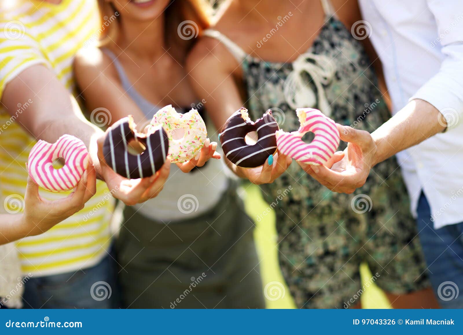 Group of Friends Eating Donuts Outdoors Stock Photo - Image of ...